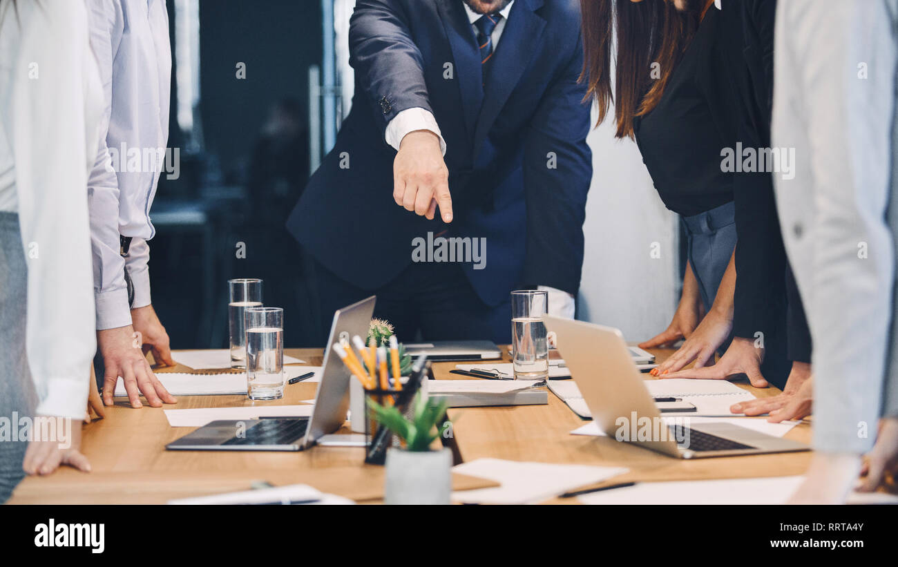 Boss hand pointing on table. Business team discussing results Stock ...