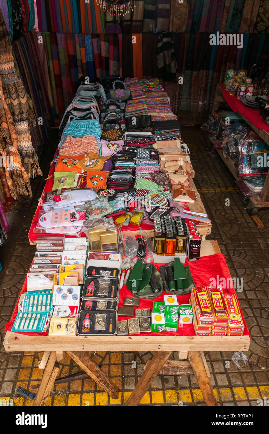 A table in a market stall with gifts, souvenirs and trinkets on display ...