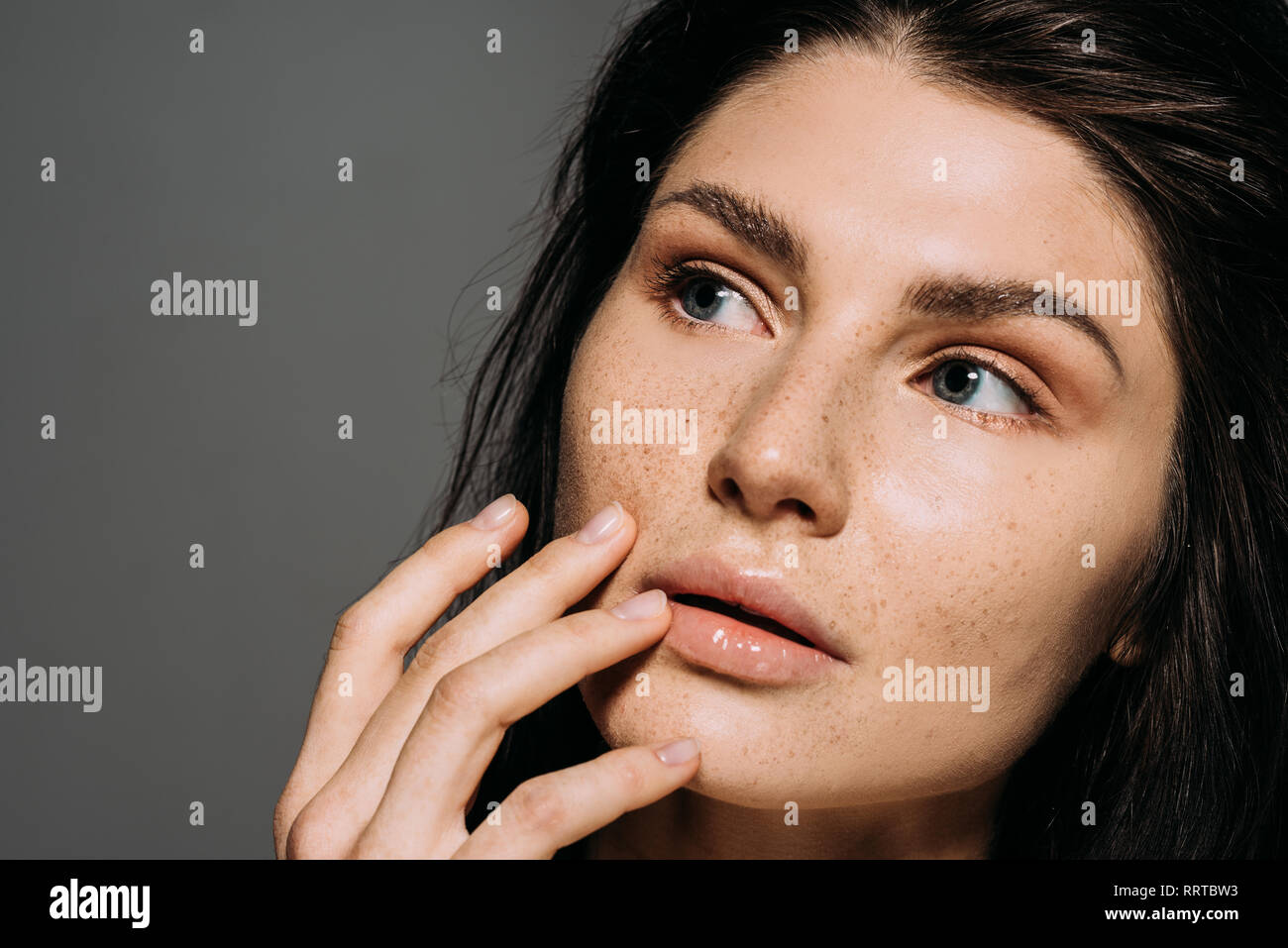 beautiful tender girl with freckles on face isolated on grey Stock ...