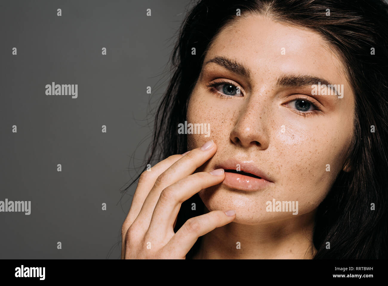 attractive tender girl with freckles on face isolated on grey Stock ...