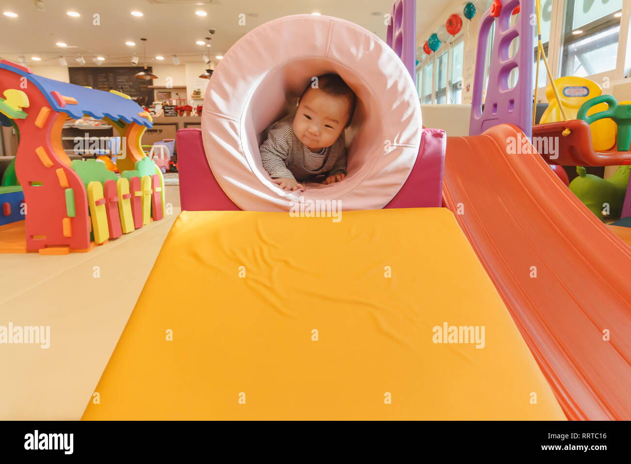 Cute Asian Korean baby playing on the indoor playground Stock Photo - Alamy