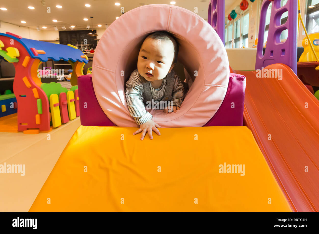 Cute Asian Korean baby playing on the indoor playground Stock Photo - Alamy