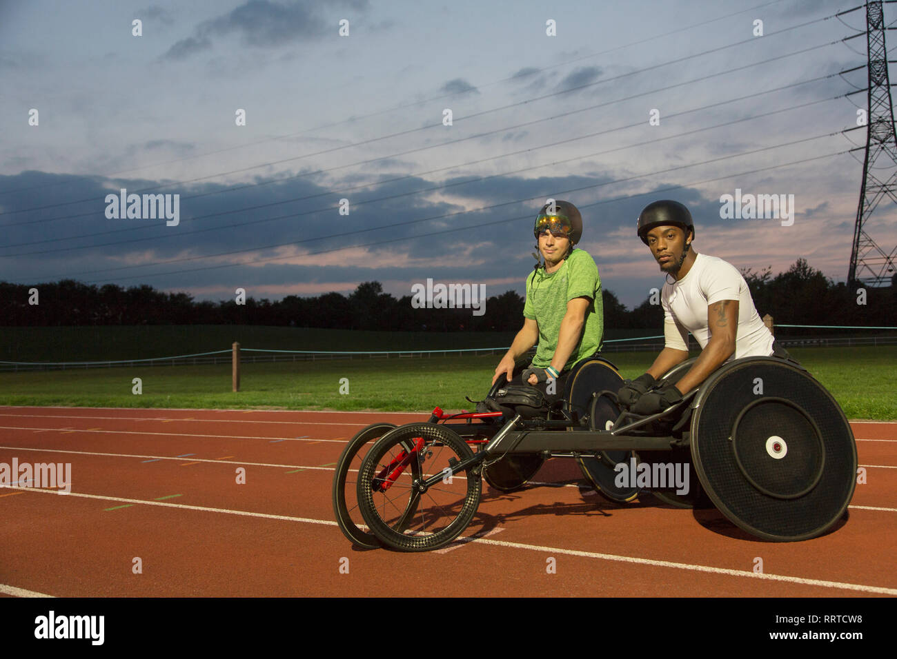 Portrait confident paraplegic athletes training for wheelchair race on ...