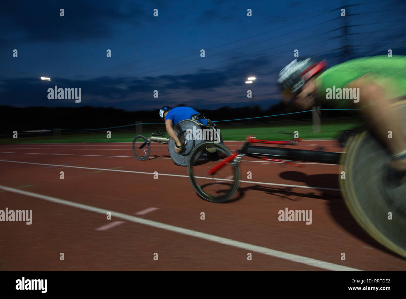 Paraplegic athletes speeding along sports track in wheelchair race at ...