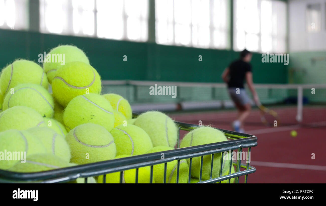Training on the tennis court. A cart filled with tennis balls Stock ...