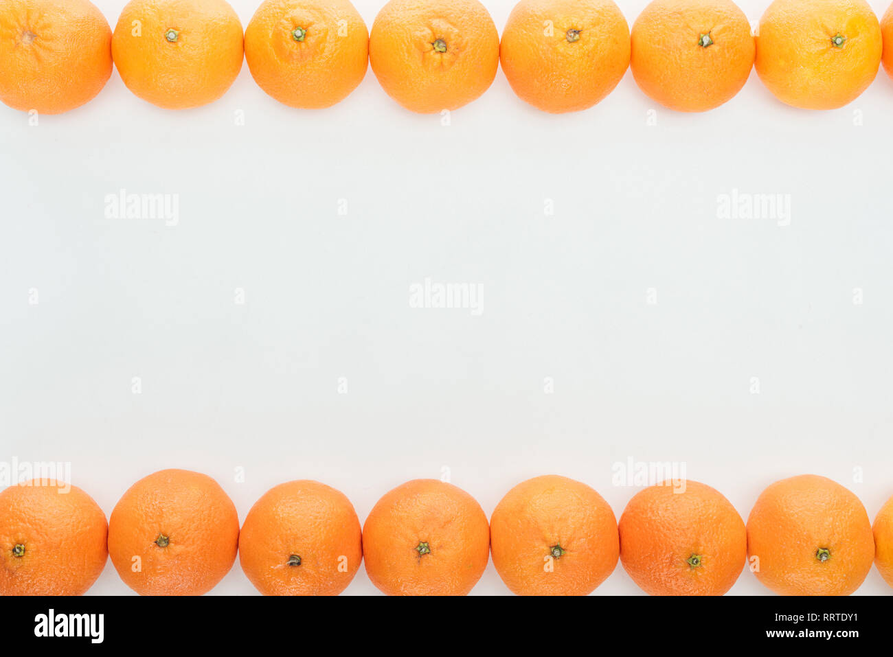 frame borders of ripe orange tangerines on white background with copy ...