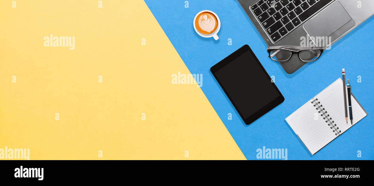 Modern office desktop workplace with laptop, tablet, notebook ...