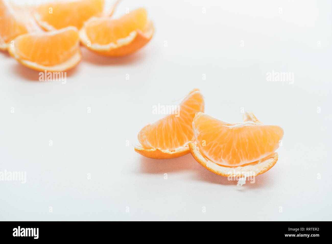 selective focus of tangerine slices with peel on white background Stock Photo - Alamy