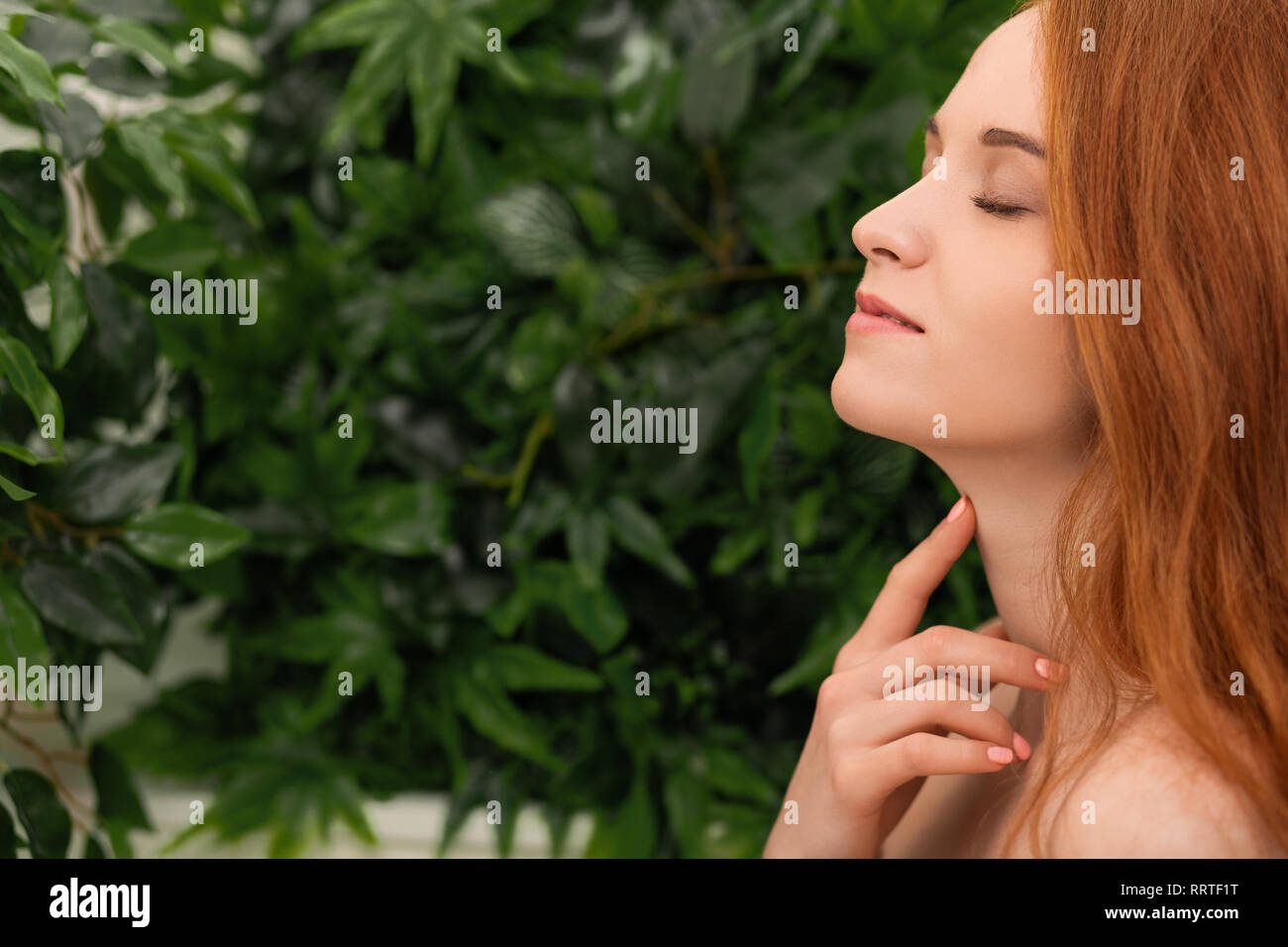 Pretty charming redhead woman touching her perfect neck Stock Photo - Alamy
