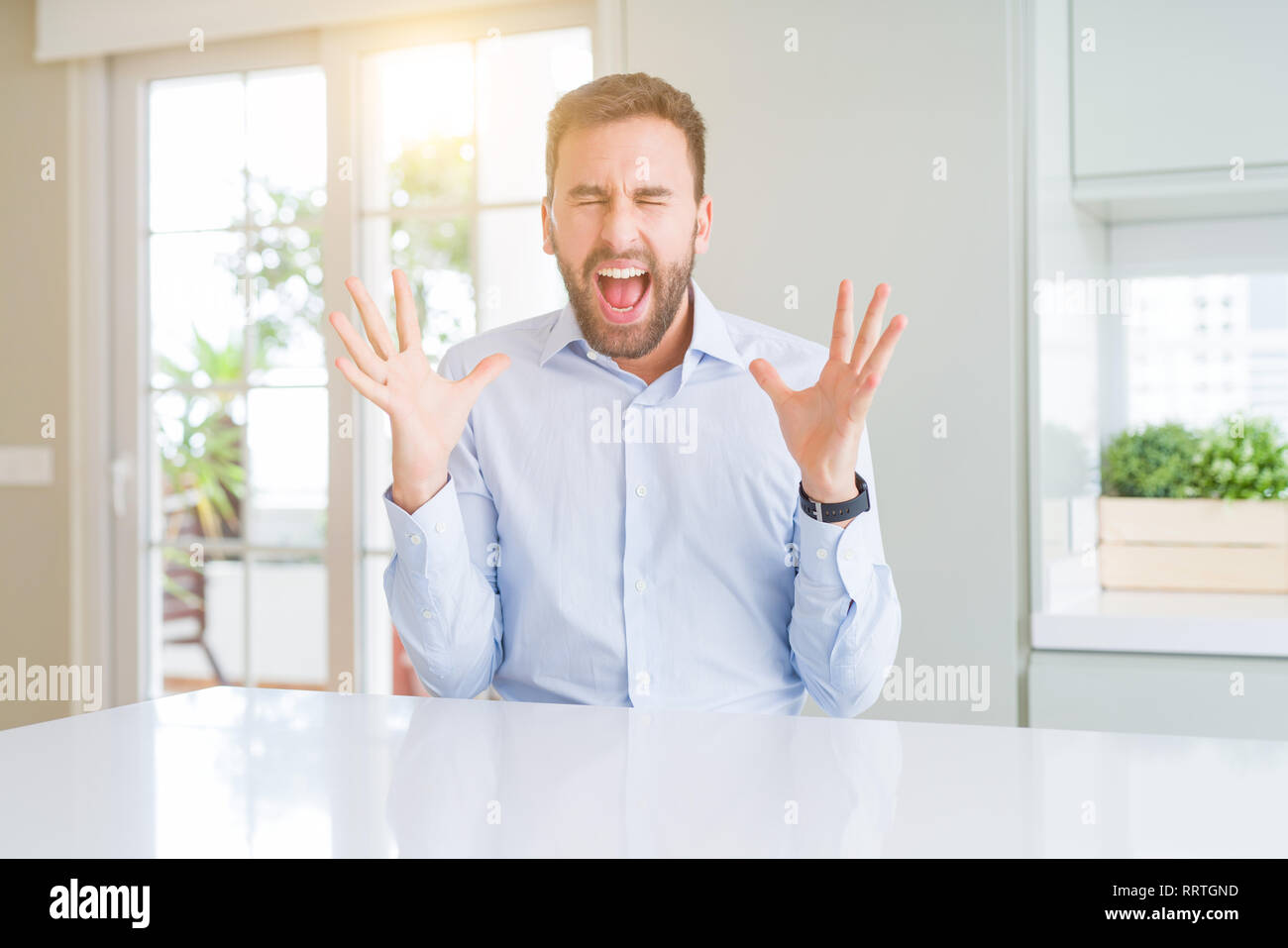 Handsome business man celebrating mad and crazy for success with arms ...