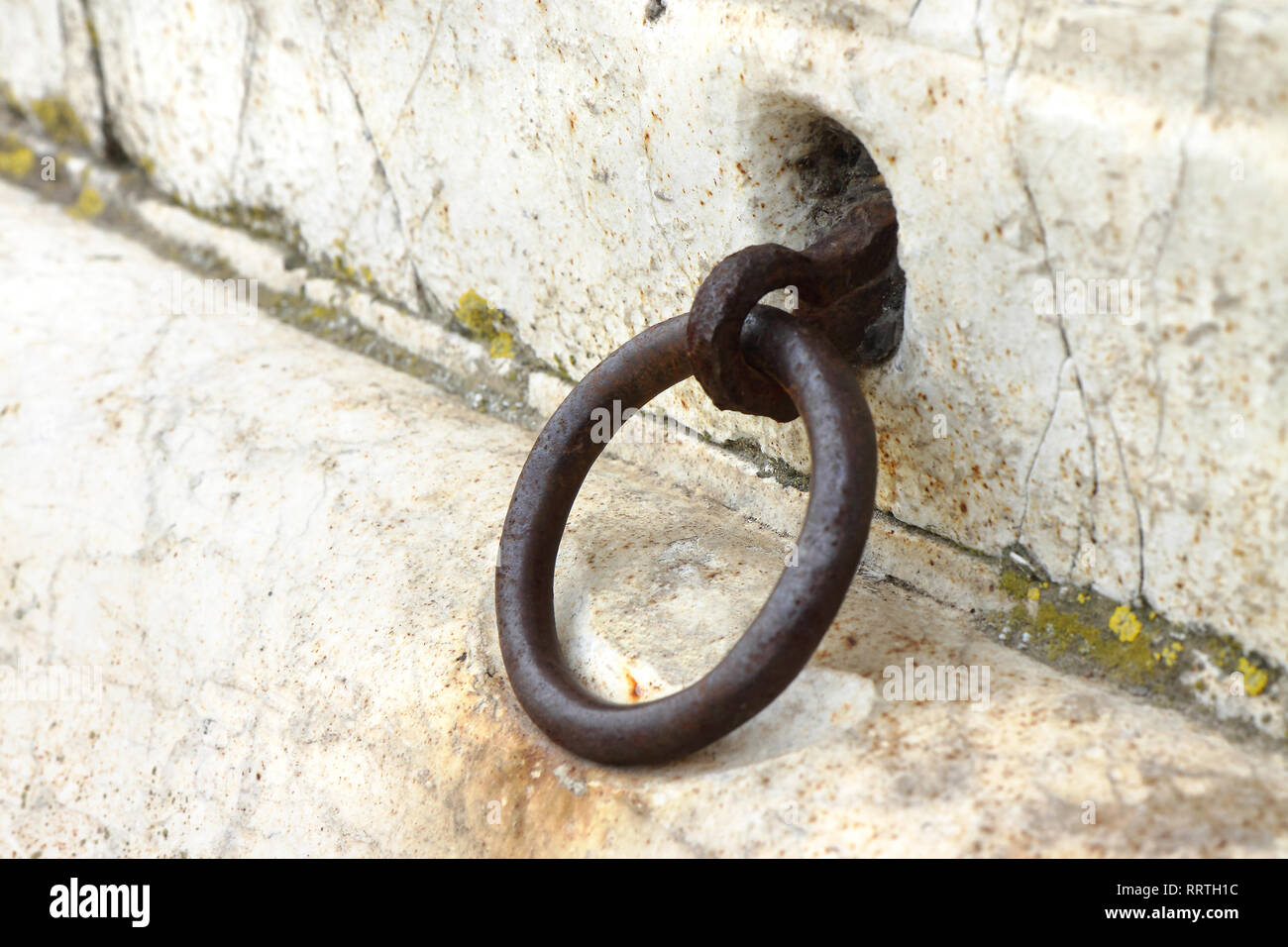 Metal ring placed in a stone wall - safety concept Stock Photo - Alamy