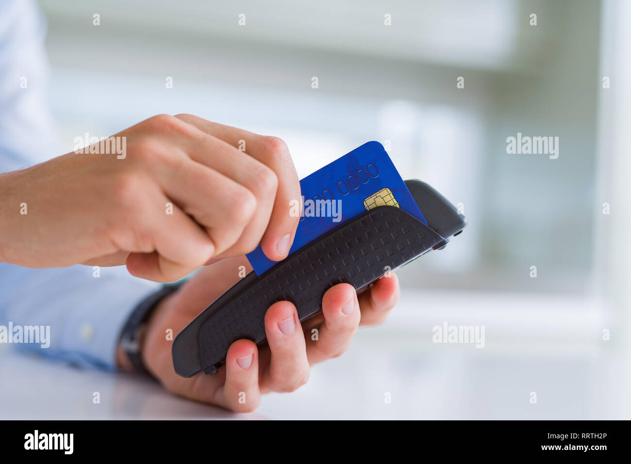 Close up of man hands holding pos terminal Stock Photo - Alamy