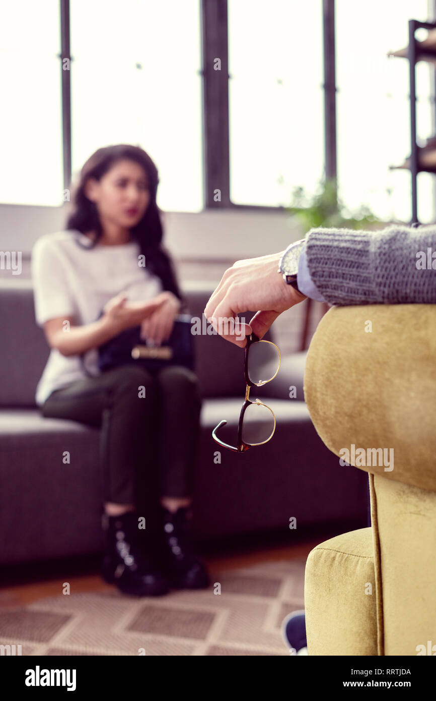 Selective focus of a male hand with glasses Stock Photo - Alamy
