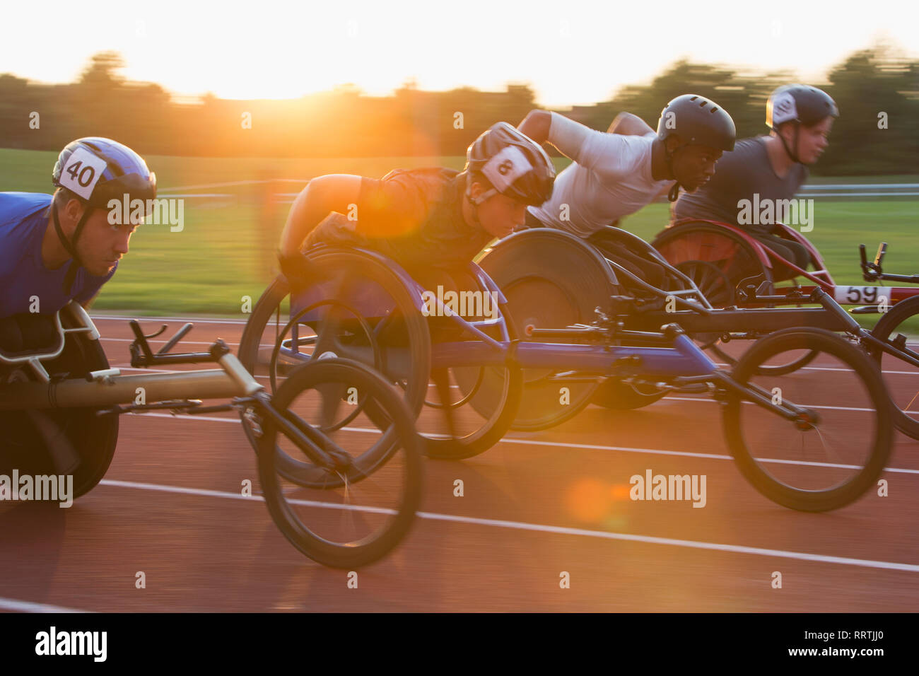 Paraplegic athletes speeding along sports track in wheelchair race ...