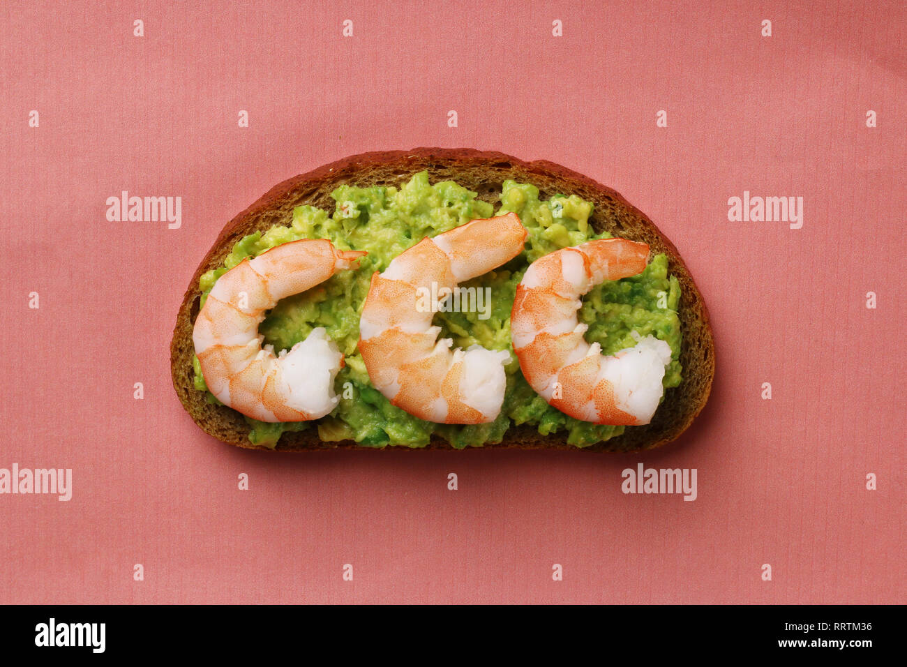 shrimp with avocado on bread with coral back top view Stock Photo - Alamy