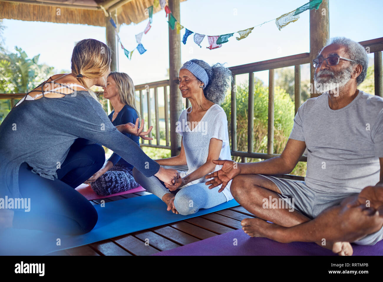 Yoga class meditating in hut during yoga retreat Stock Photo - Alamy