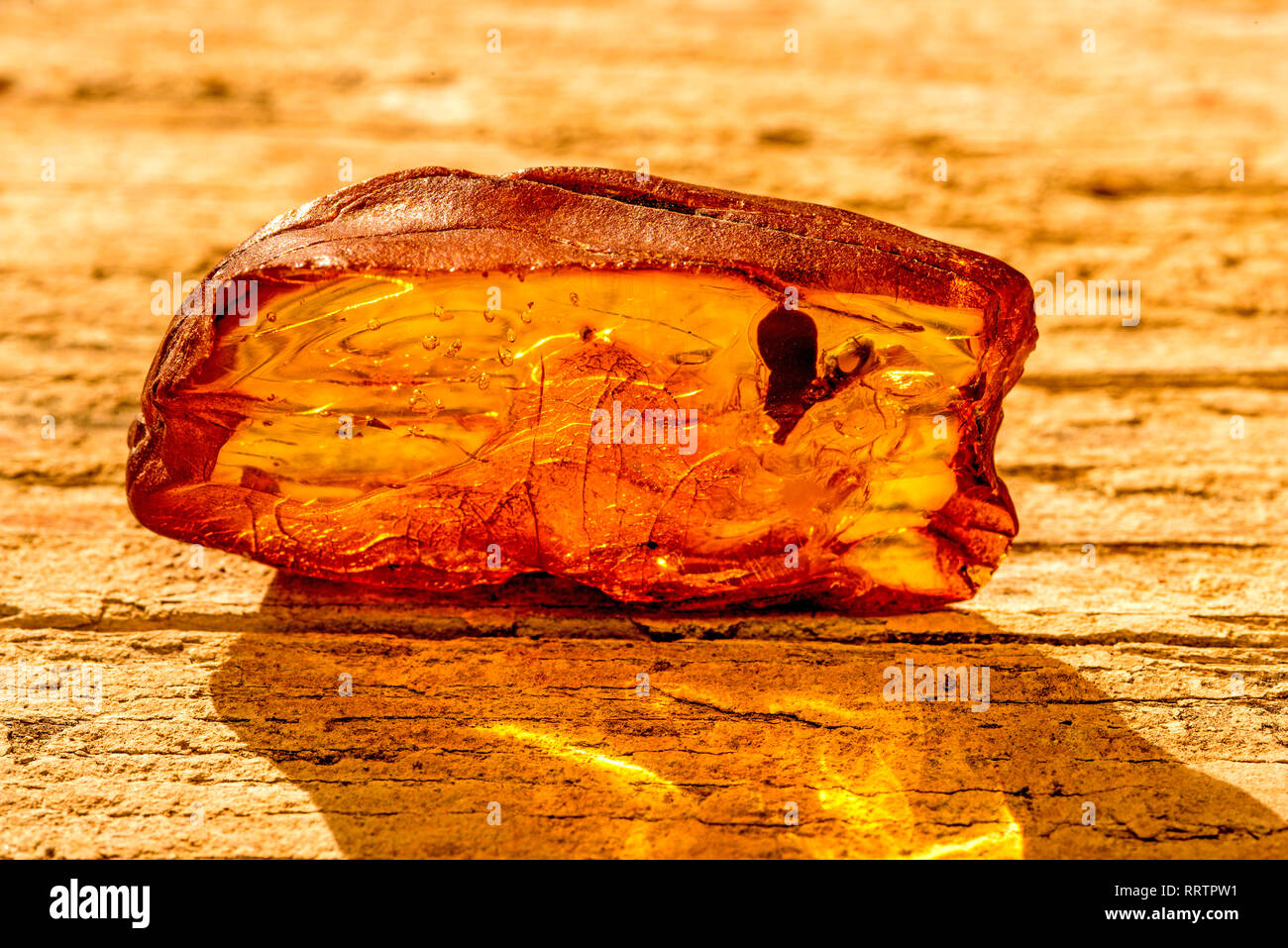 Amber in sun with inclusions Stock Photo - Alamy
