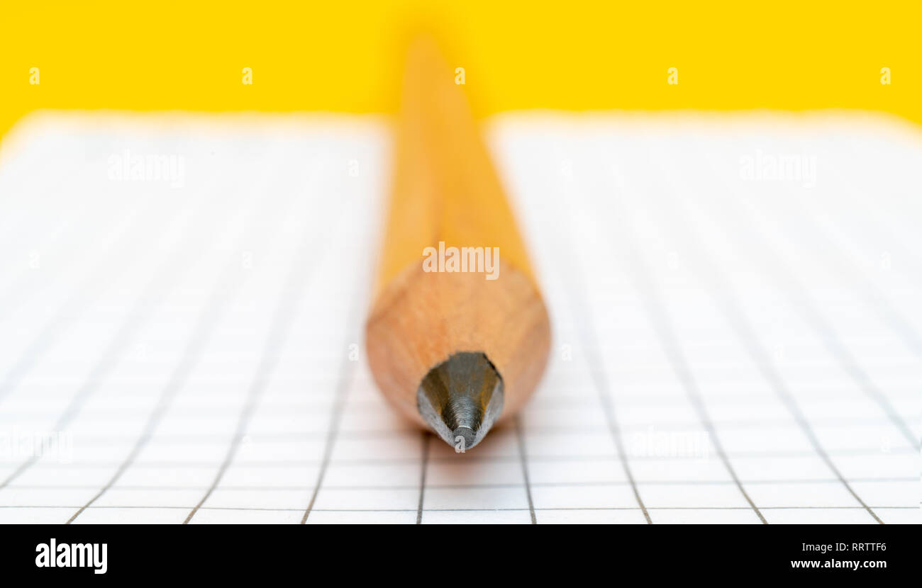 Huge pencil and checkered notepad page Stock Photo - Alamy
