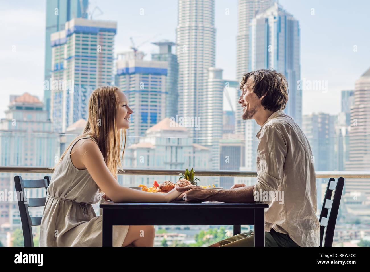 Loving couple having breakfast on the balcony. Breakfast table with ...