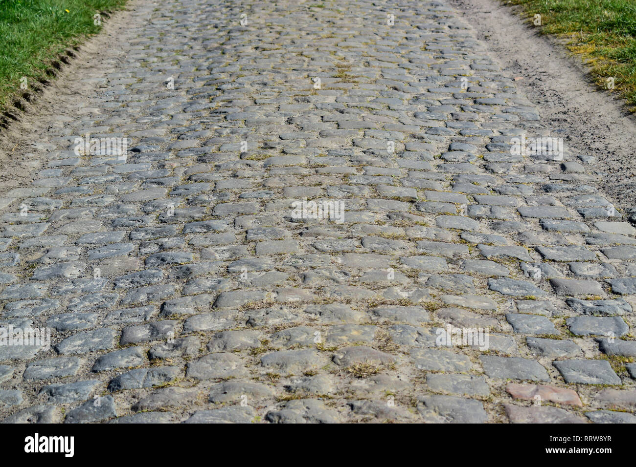 View of an old gray road covered with a stone cube Stock Photo - Alamy