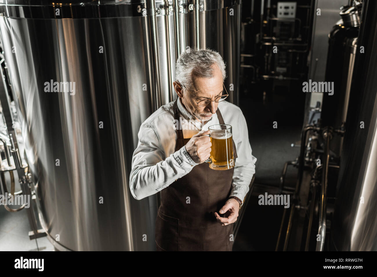 senior owner testing beer in professional brewery Stock Photo - Alamy