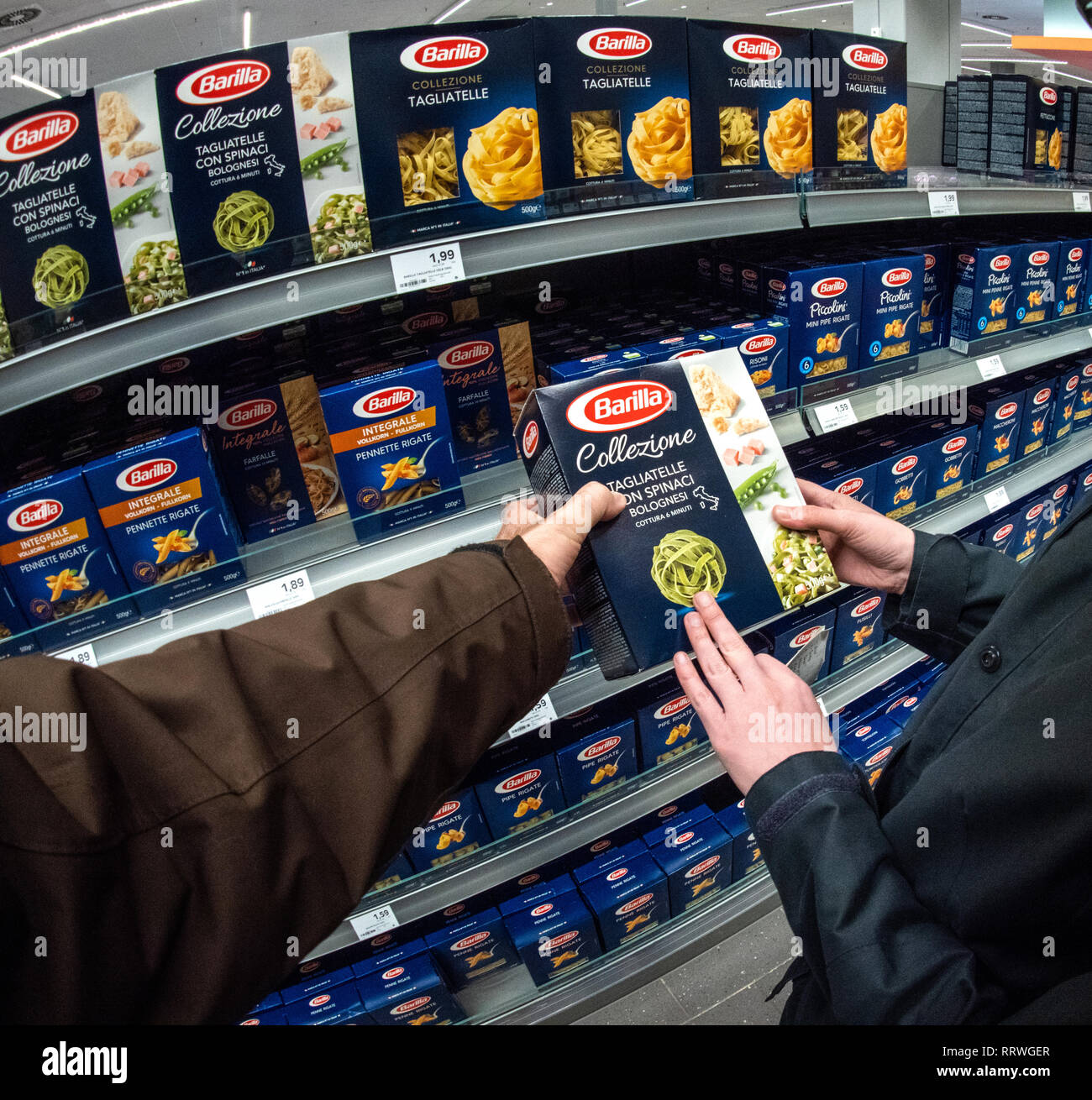 FRANKFURT, GERMANY - MAR 5, 2017: Man and woman buying Barilla Pasta ...
