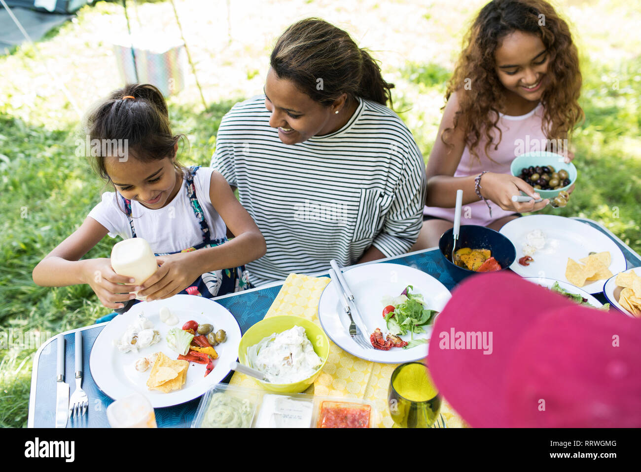 Family enjoying lunch at campsite Stock Photo - Alamy