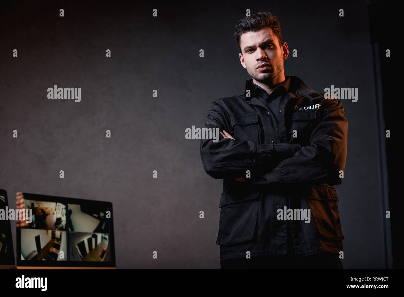 Male security guard arms crossed hi-res stock photography and images ...