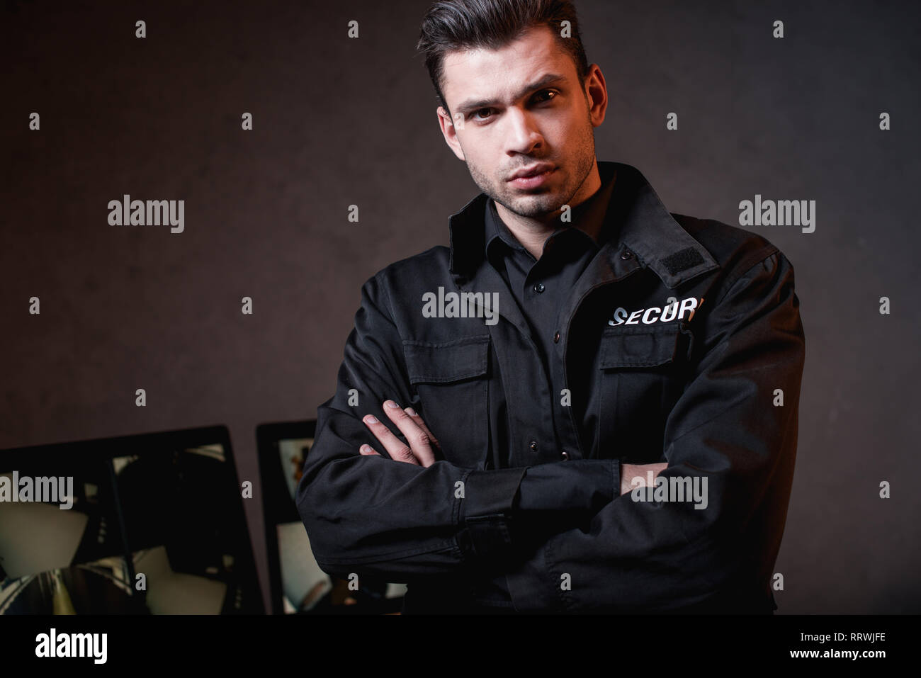 Male security guard arms crossed hi-res stock photography and images ...