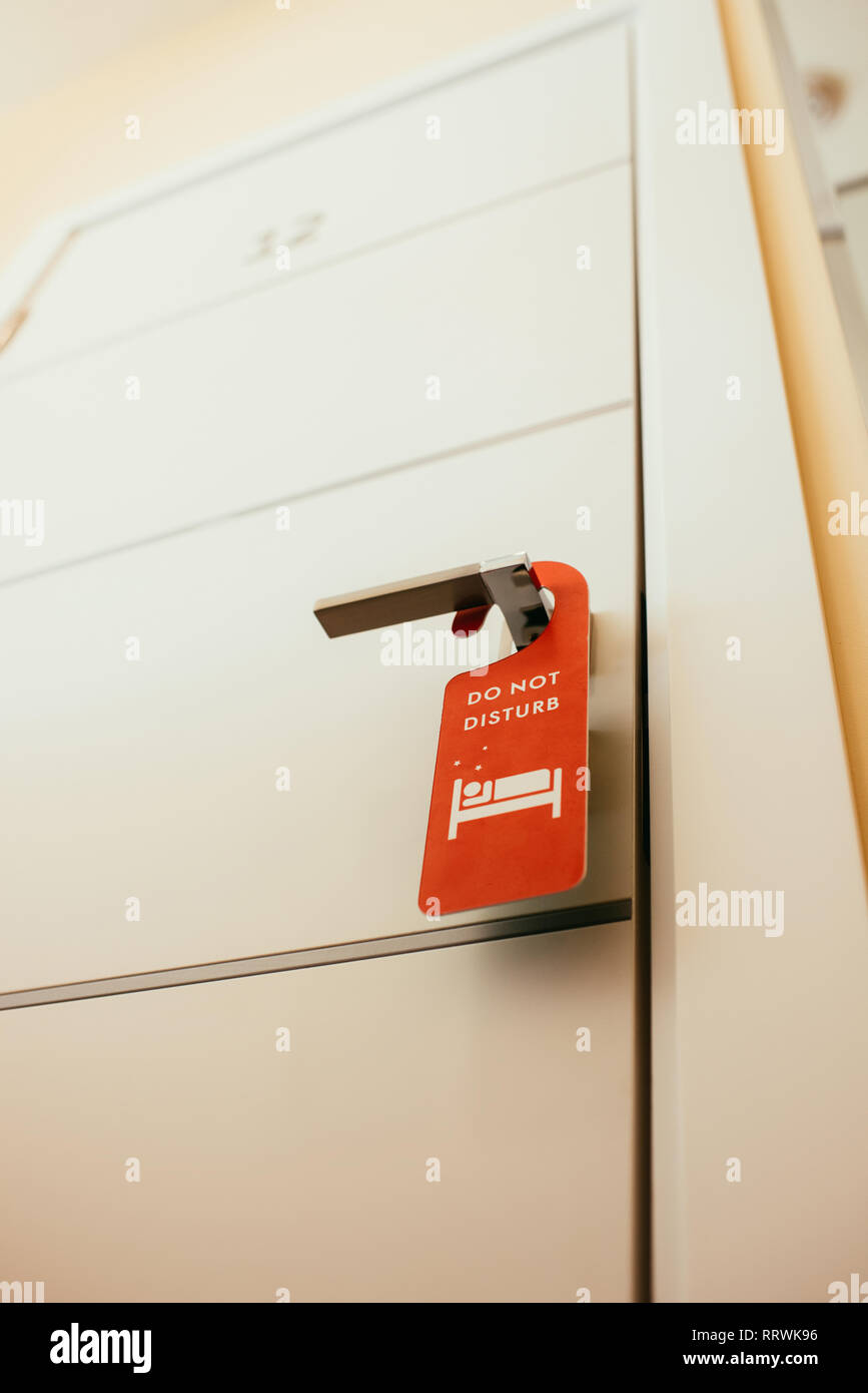 red symbol with "do not disturb" lettering on door handle in hotel ...