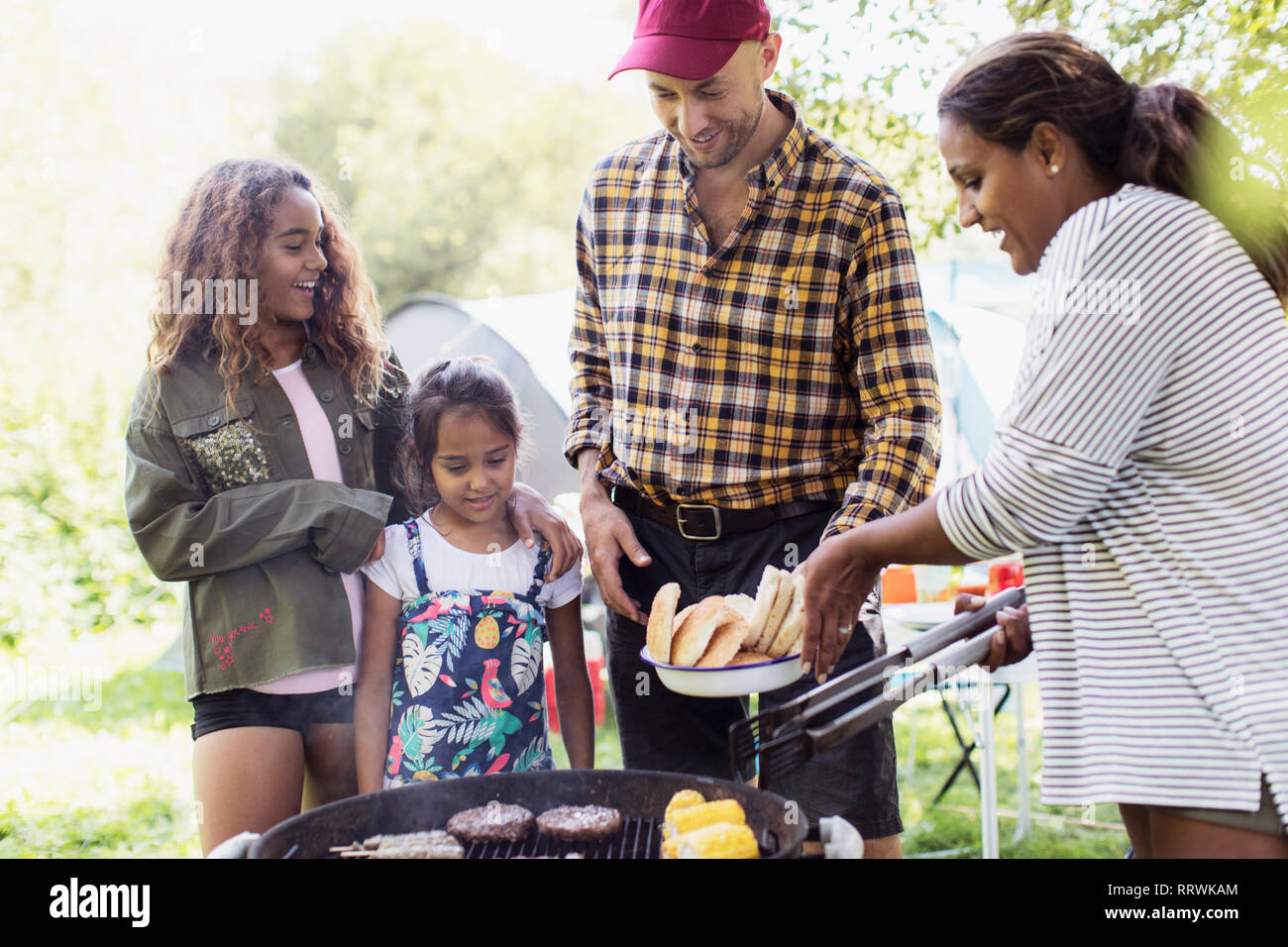 Family barbecuing at campsite Stock Photo - Alamy