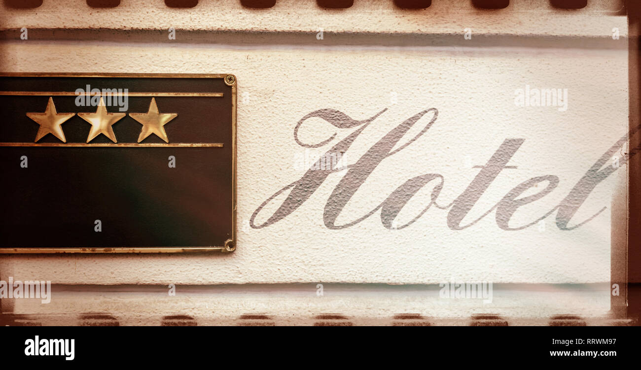 Beautiful HOTEL calligraphy sign next to three stars metallic plate ...