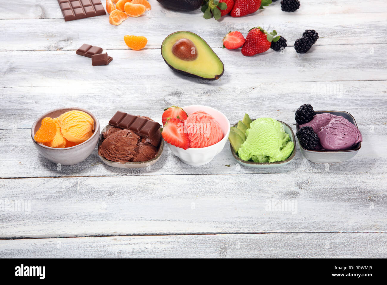 Set of ice cream scoops of different colors and flavours with berries ...