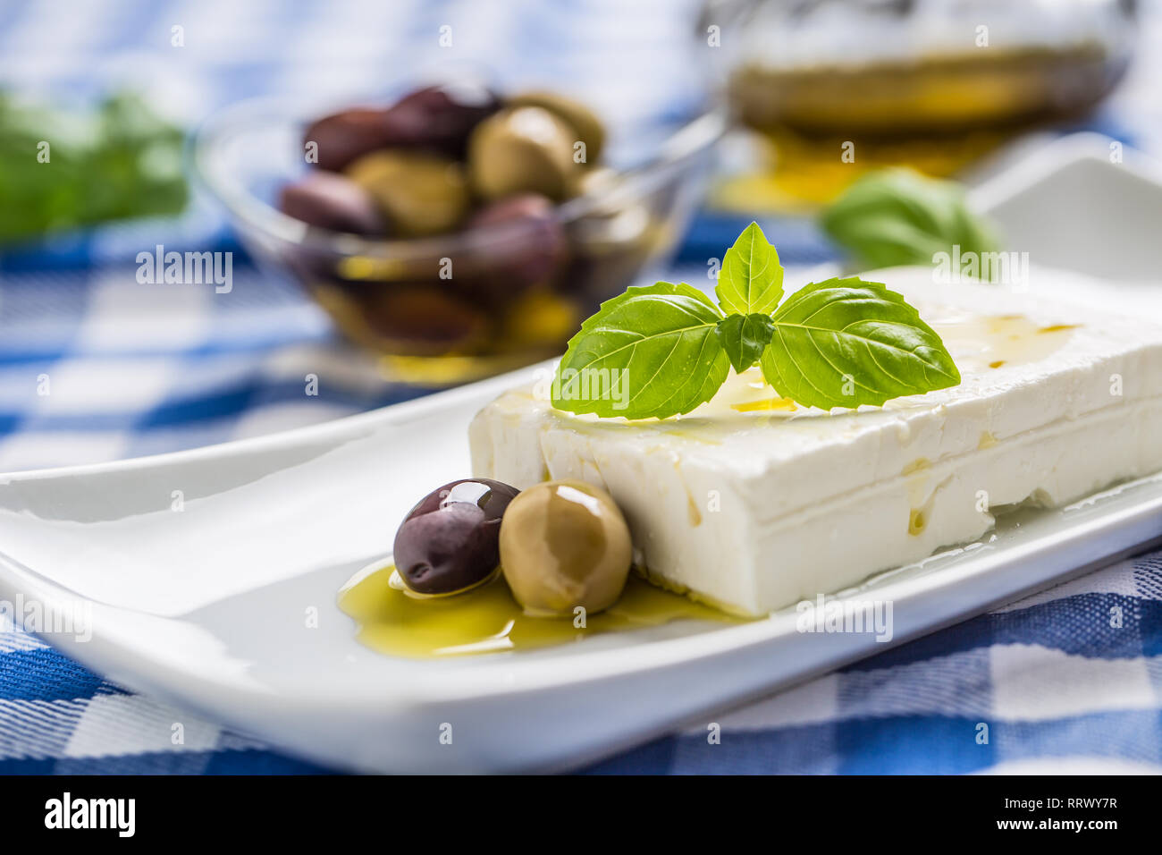 Greek cheese feta with olive oil olives and basil leaves Stock Photo ...