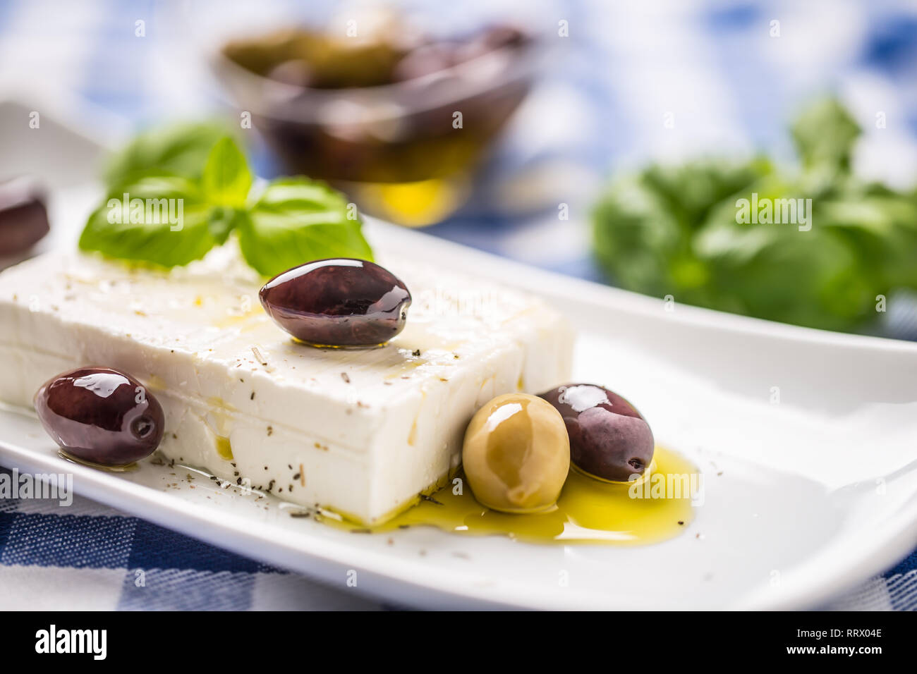 Greek cheese feta with olive oil olives and basil leaves Stock Photo ...