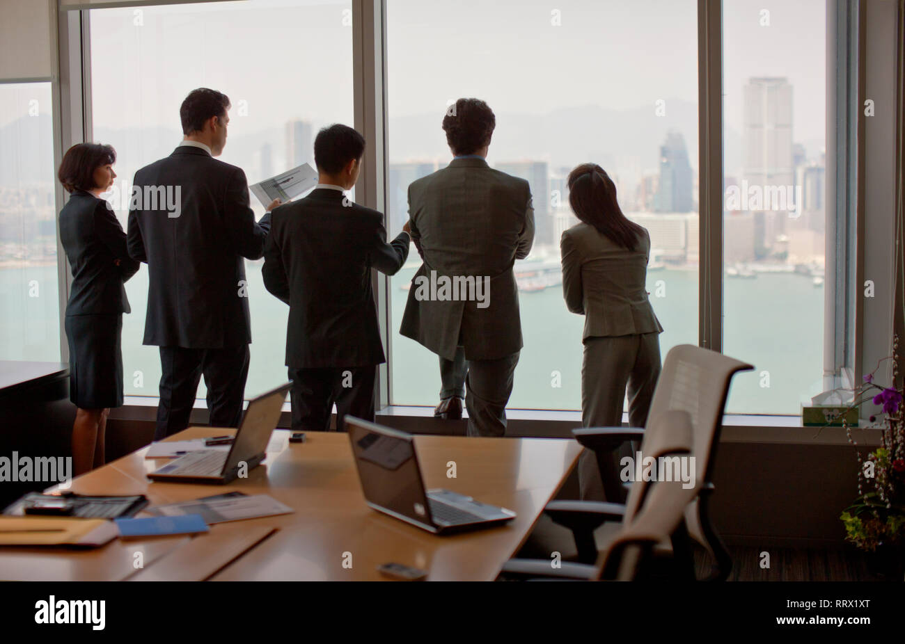 Group of people looking through the window of an office building Stock ...