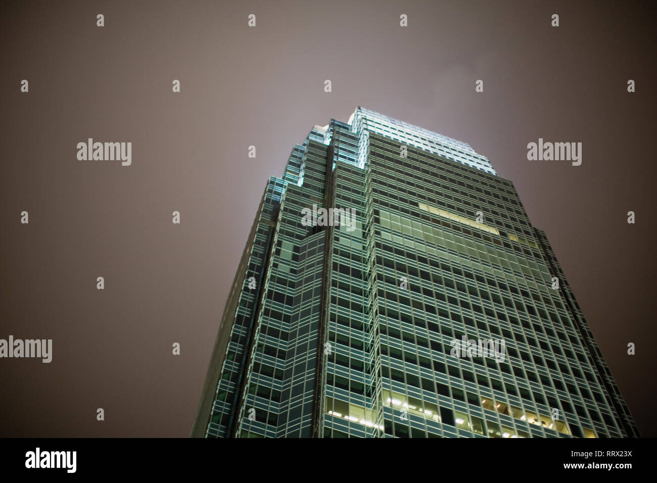 Tall illuminated skyscraper at night Stock Photo - Alamy
