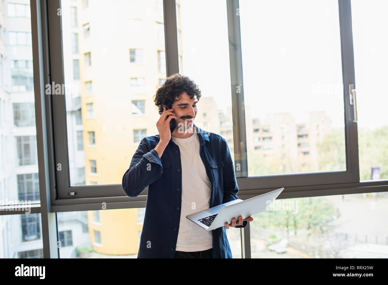Man standing using phone hi-res stock photography and images - Alamy