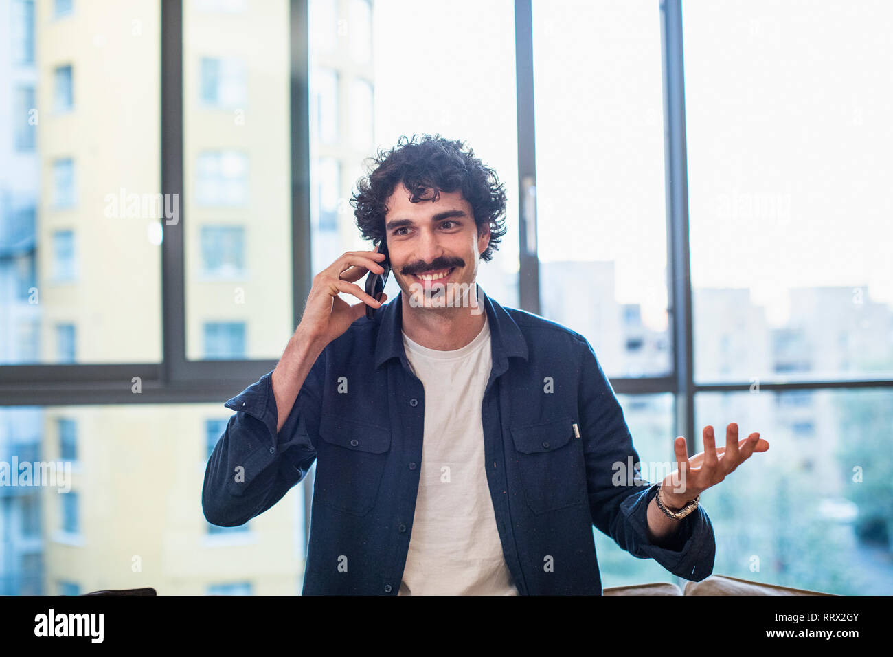 Black man on his phone smiling hi-res stock photography and images - Alamy