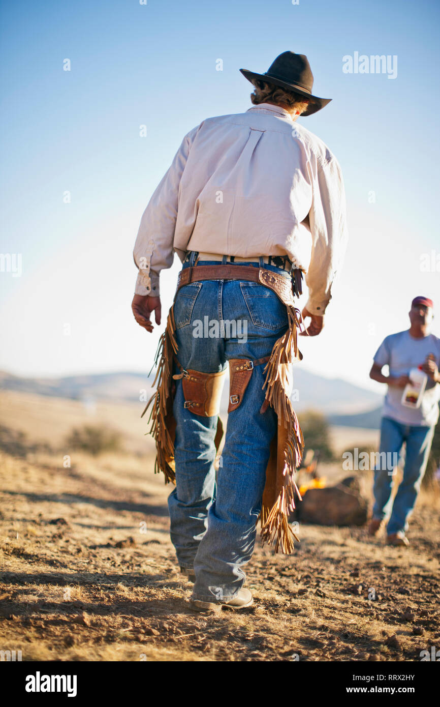 Rancher working on a dusty farm Stock Photo - Alamy