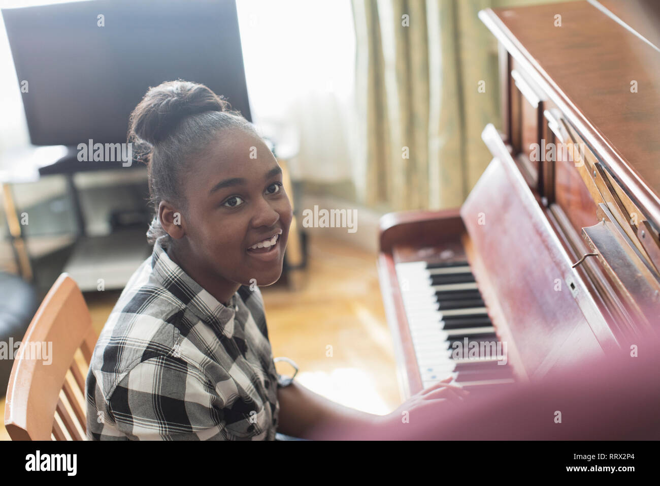 Smiling girl playing piano Stock Photo - Alamy