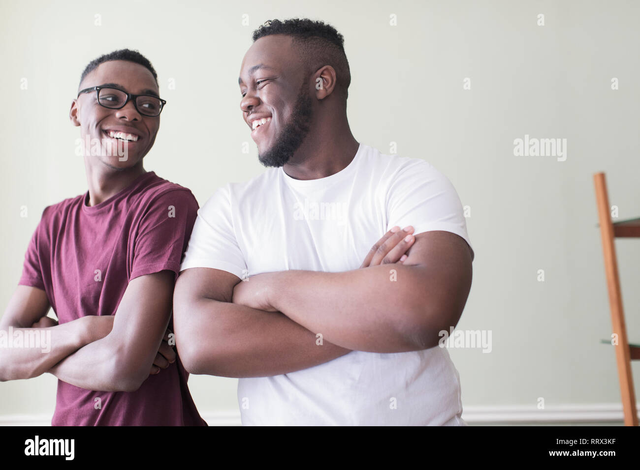 Portrait confident teenage brothers with arms crossed Stock Photo - Alamy