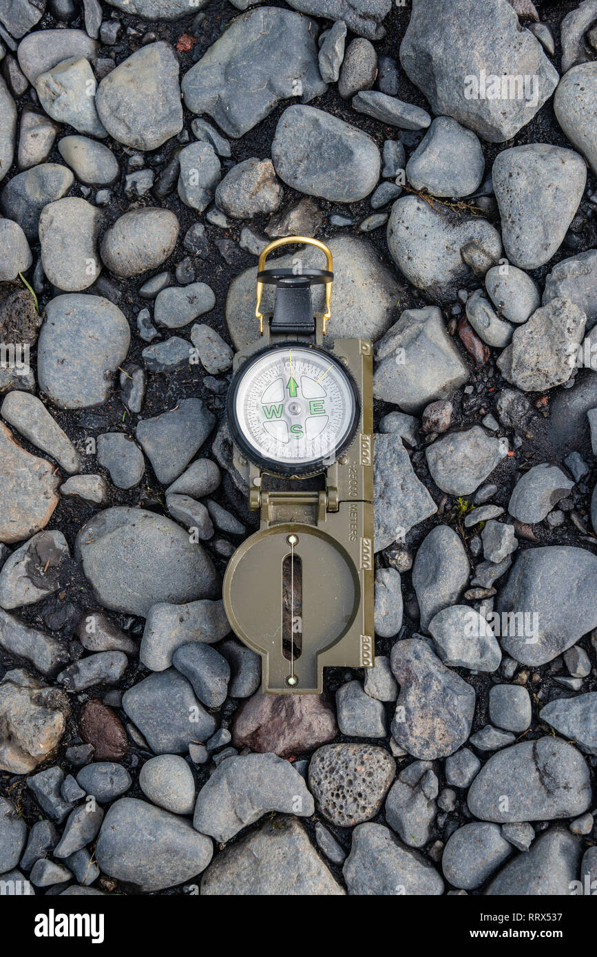 An old green military compass lying on gravel Stock Photo - Alamy