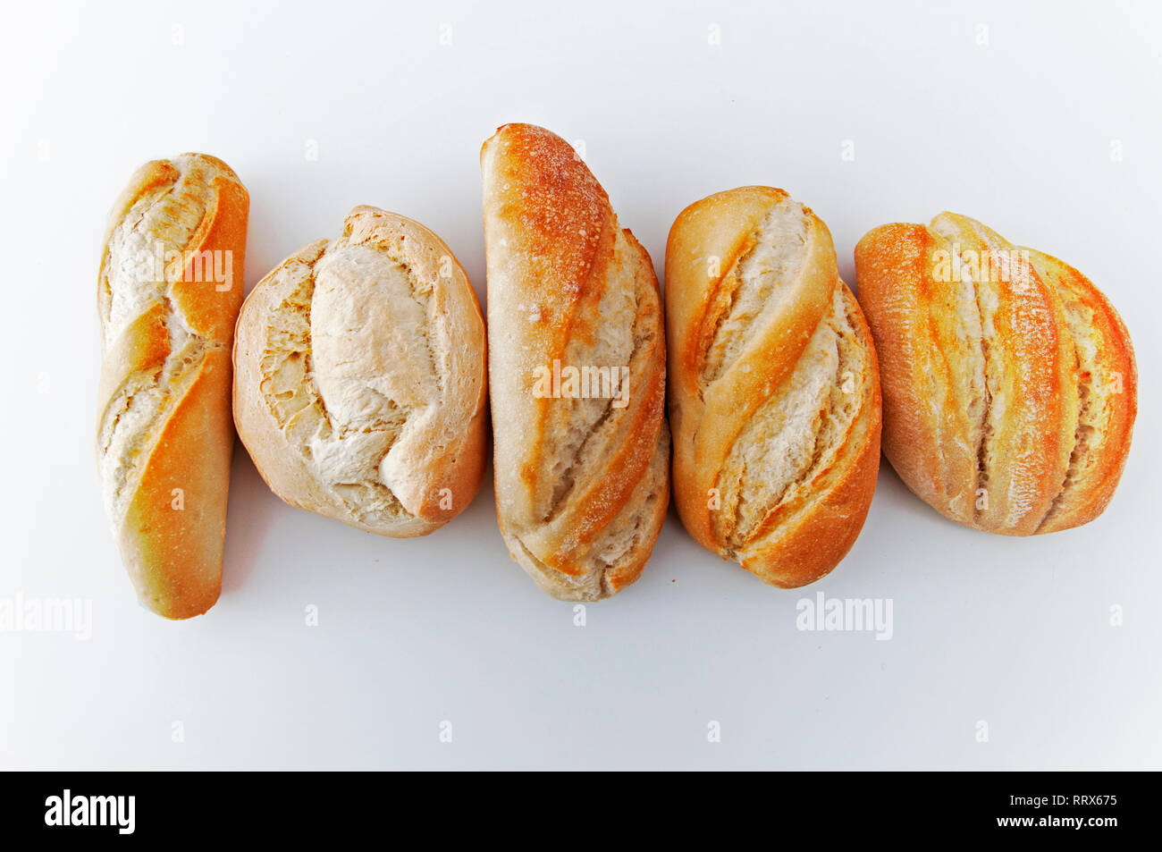 Five different small brown breads on the white background Stock Photo ...