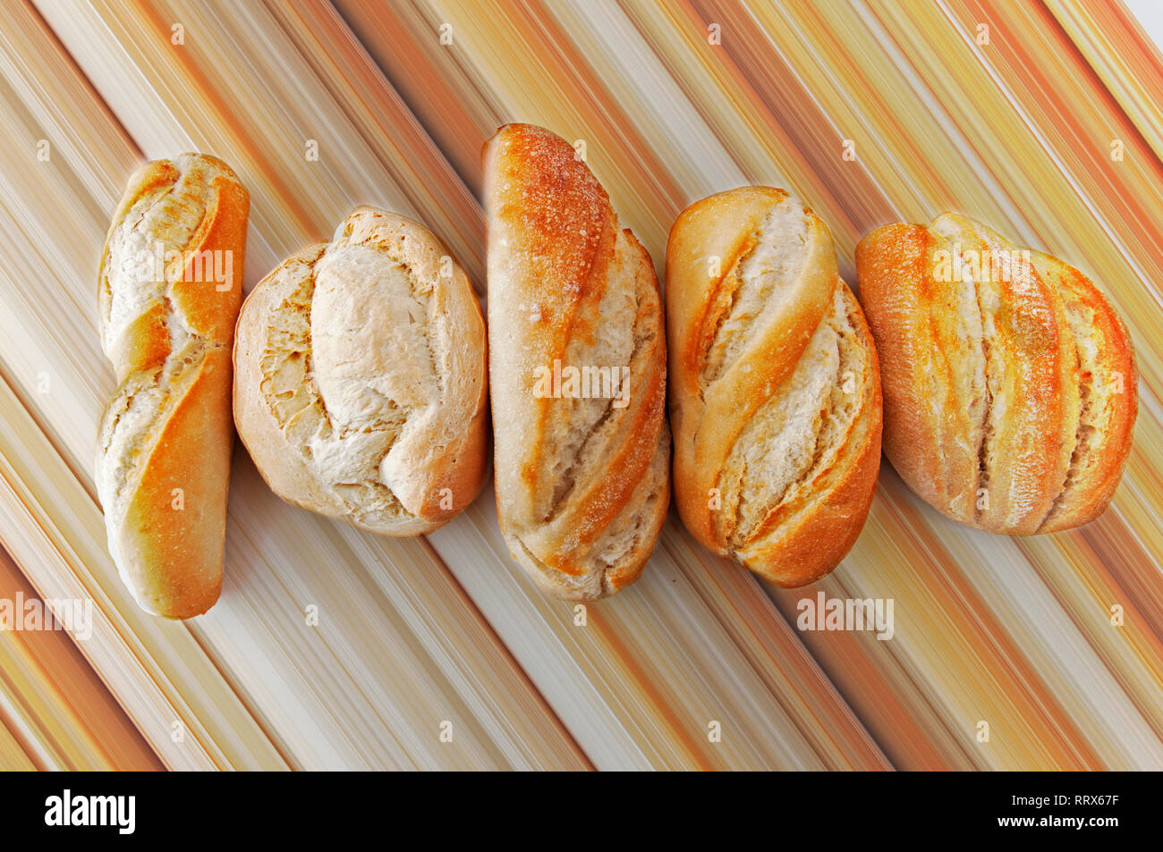 Five small brown breads with the linear background of the same color ...