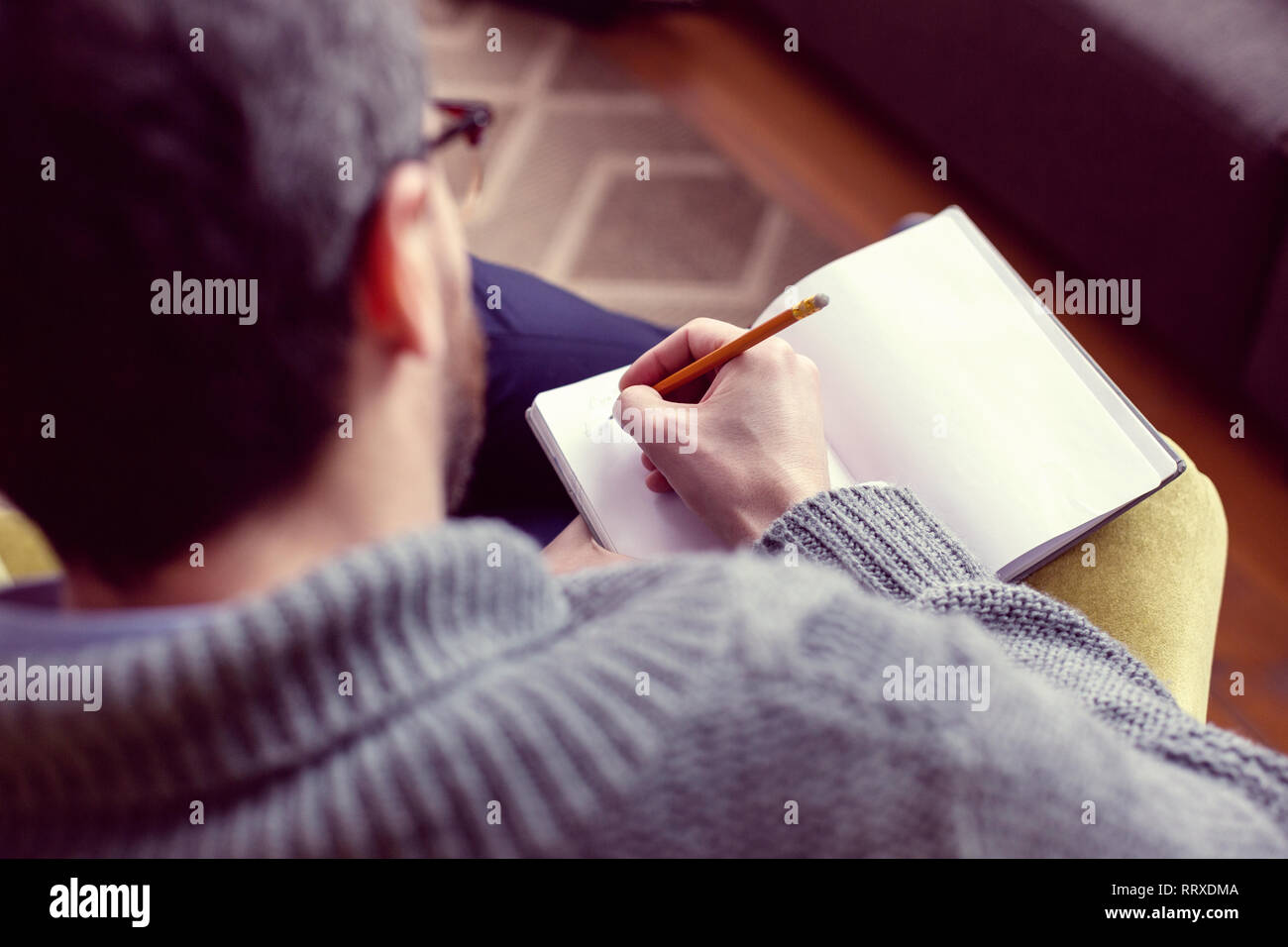 Top view of a nice man holding his pen Stock Photo - Alamy