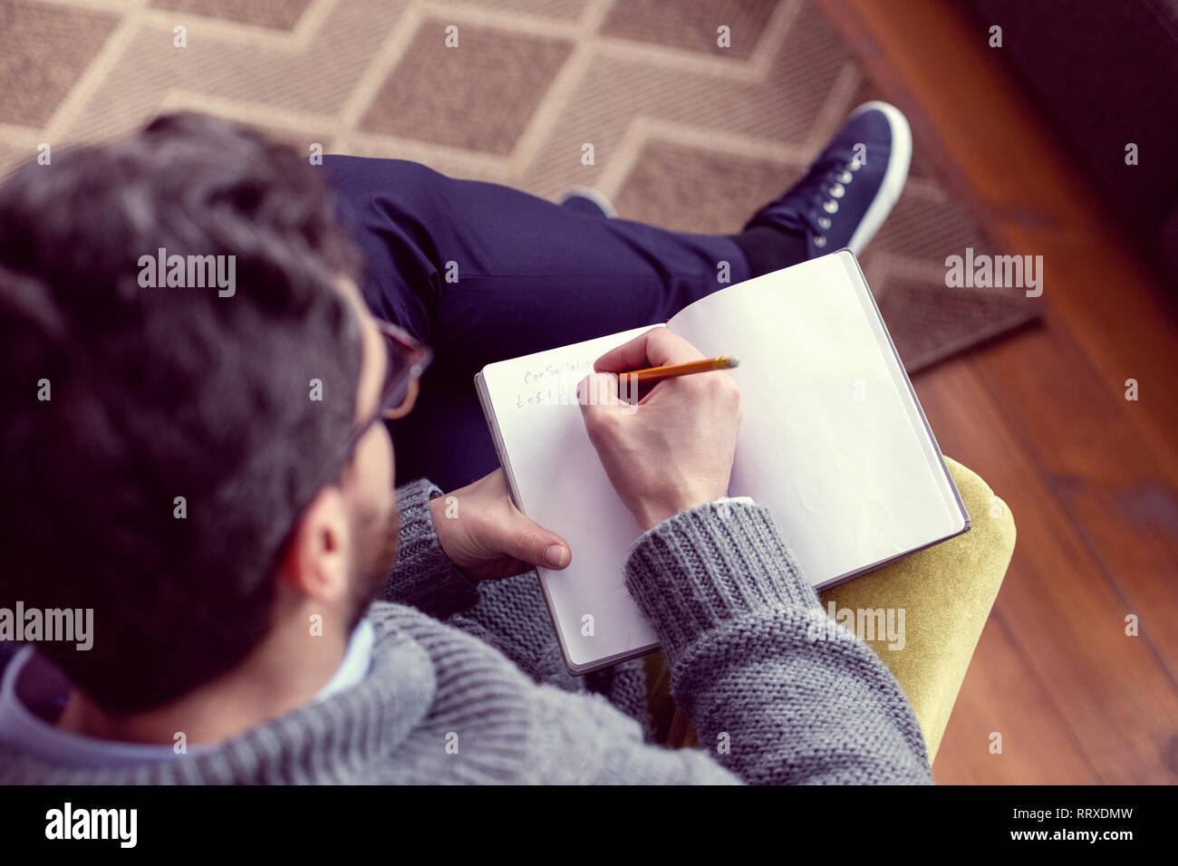 Top view of a serious smart man writing Stock Photo - Alamy