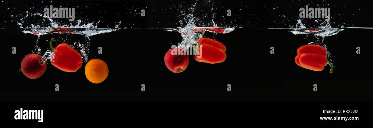 Fresh apple, orange and pepper water splash on black Stock Photo - Alamy