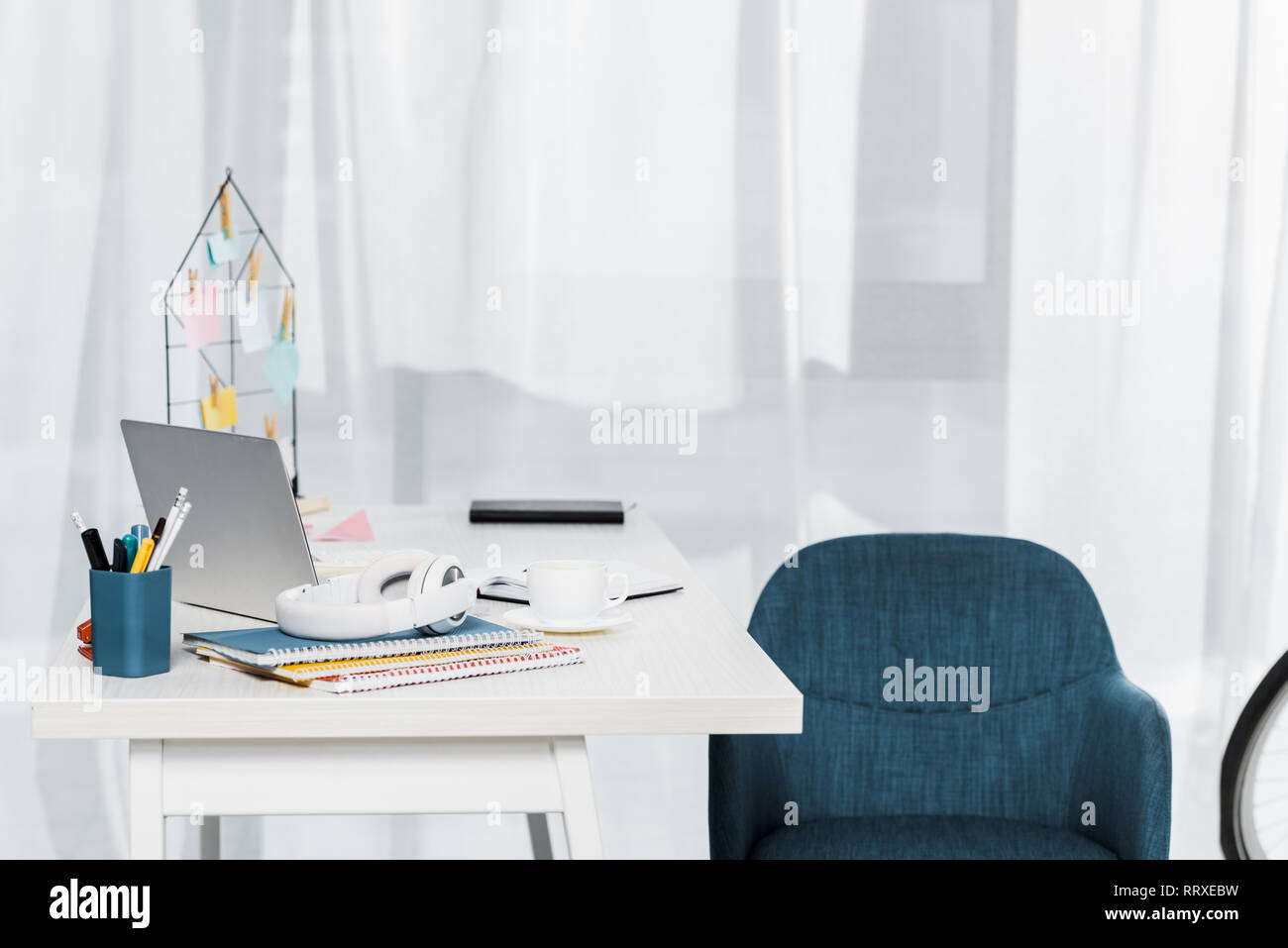 Cozy home office with laptop, notebooks and stylish furniture Stock ...