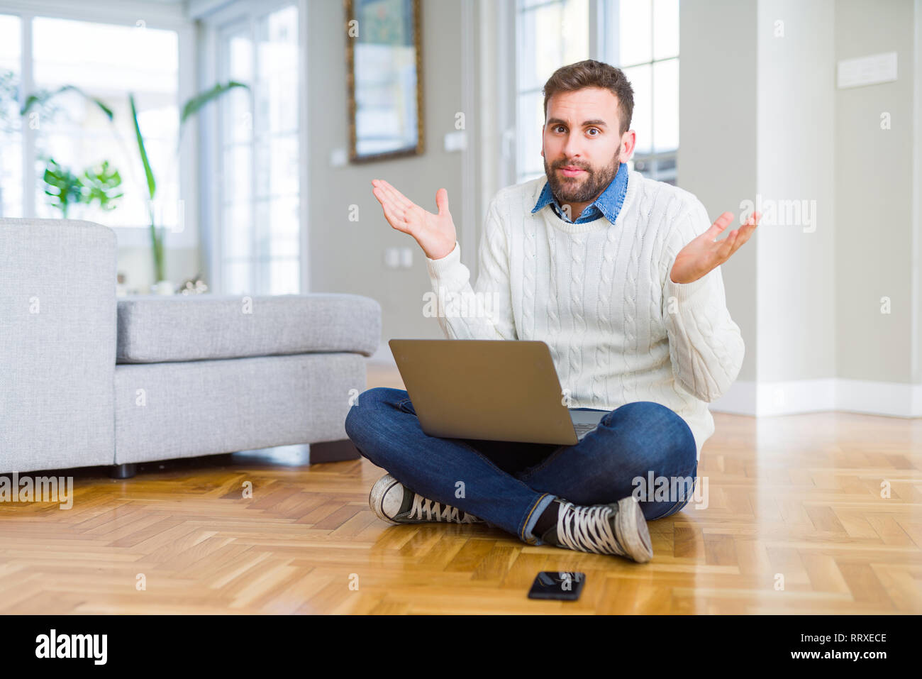 Handsome man wearing working using computer laptop clueless and ...